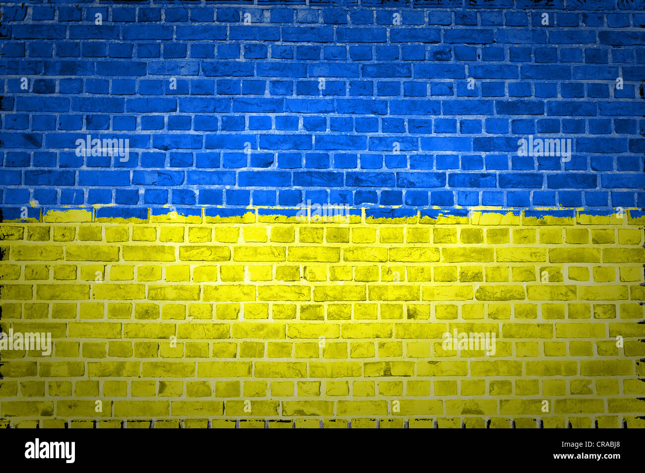 An image of the Ukraine flag painted on a brick wall in an urban ...