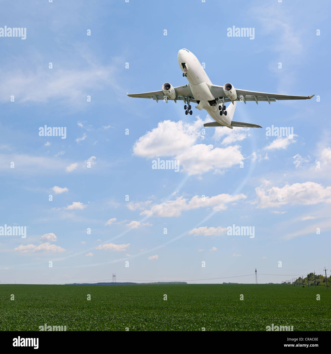 Passenger aircraft taking off over the fields Stock Photo - Alamy
