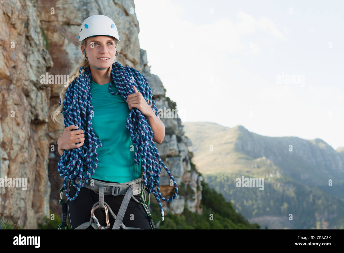 Climber holding coiled rope on mountain Stock Photo - Alamy