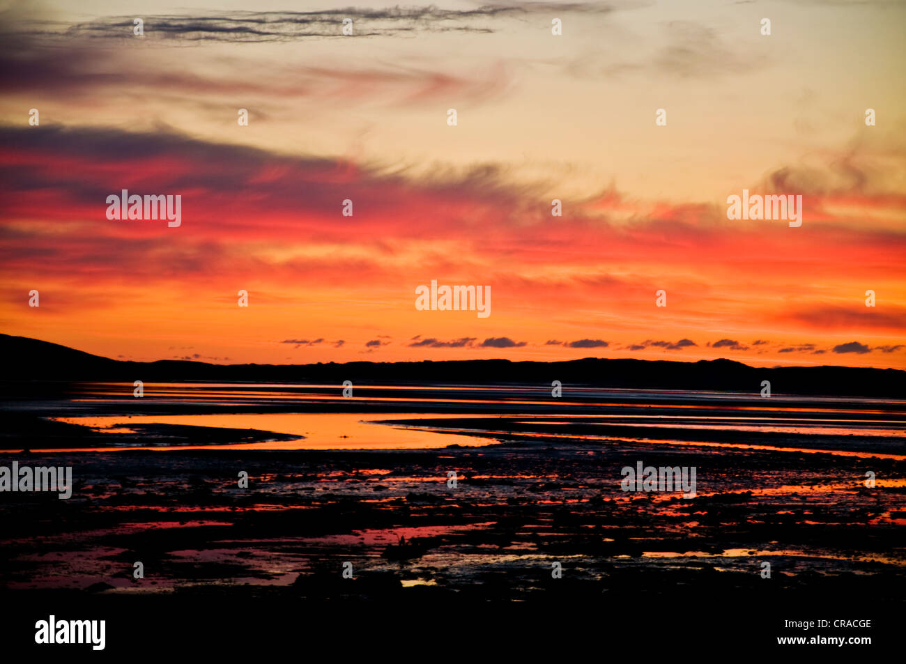 Vibrant sunset over mudflats on west coast of Ireland Stock Photo - Alamy