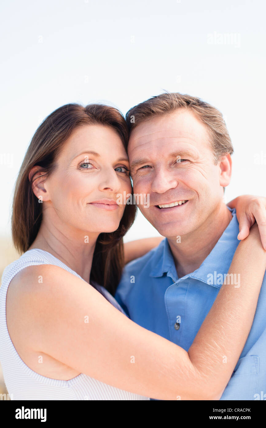 Smiling couple hugging outdoors Stock Photo - Alamy
