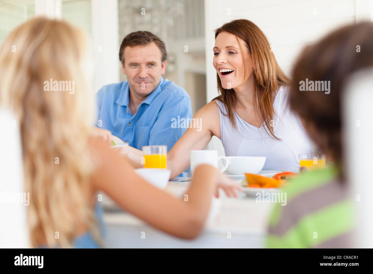 Family eating together at table Stock Photo - Alamy