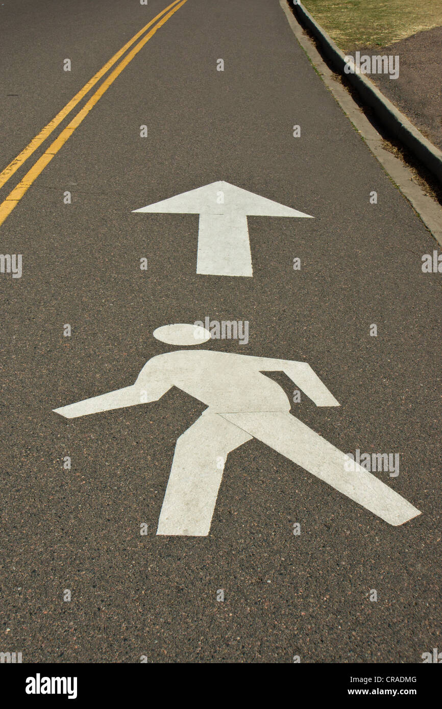 White silhouette figure of walker on street with arrow showing walking ...