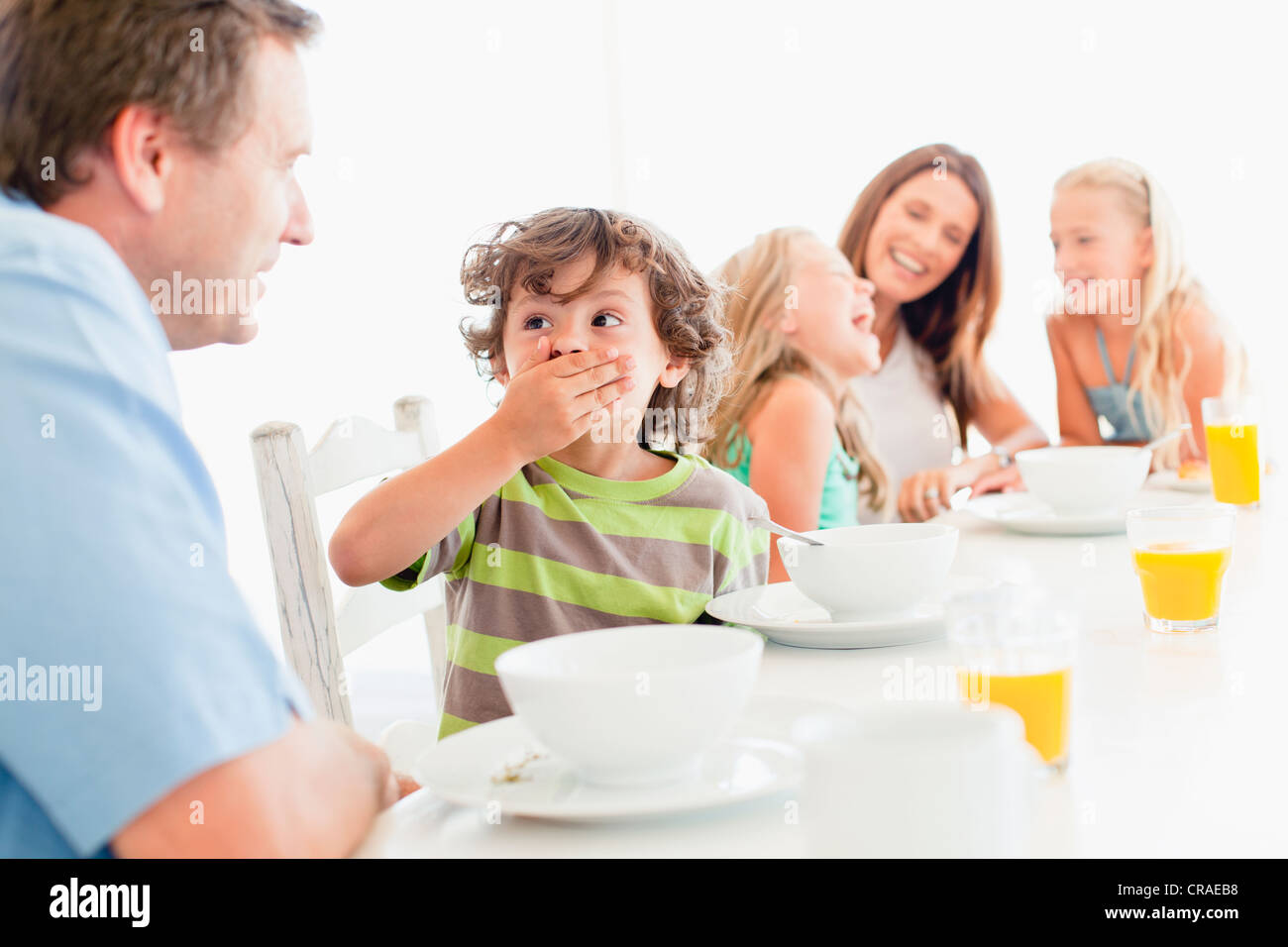 Family talking at breakfast table Stock Photo - Alamy