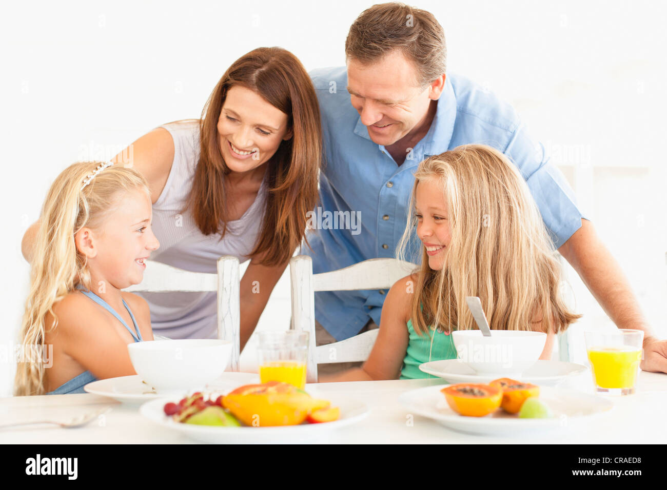 Family talking at breakfast table Stock Photo - Alamy