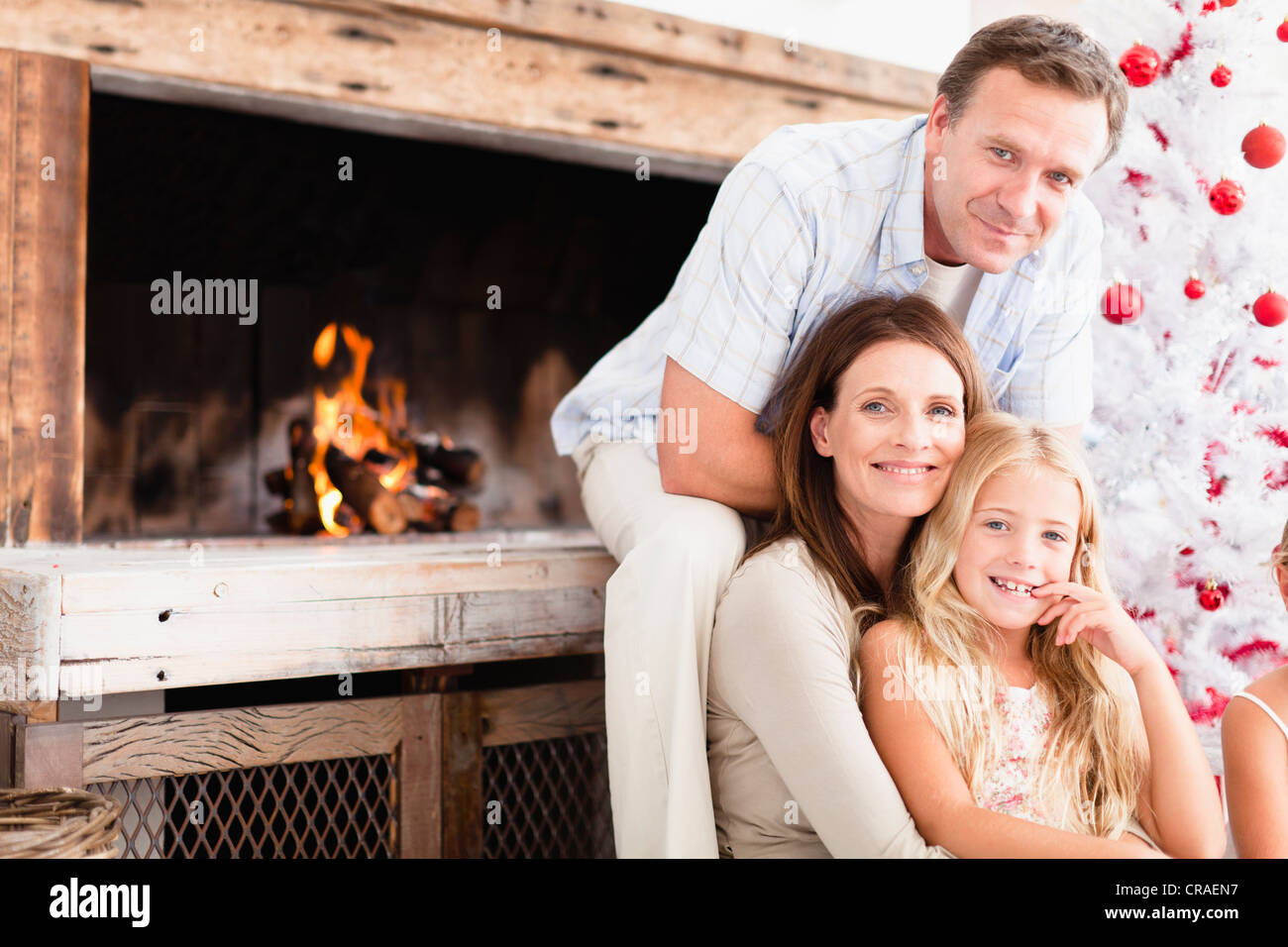 Family around christmas tree hi-res stock photography and images - Alamy