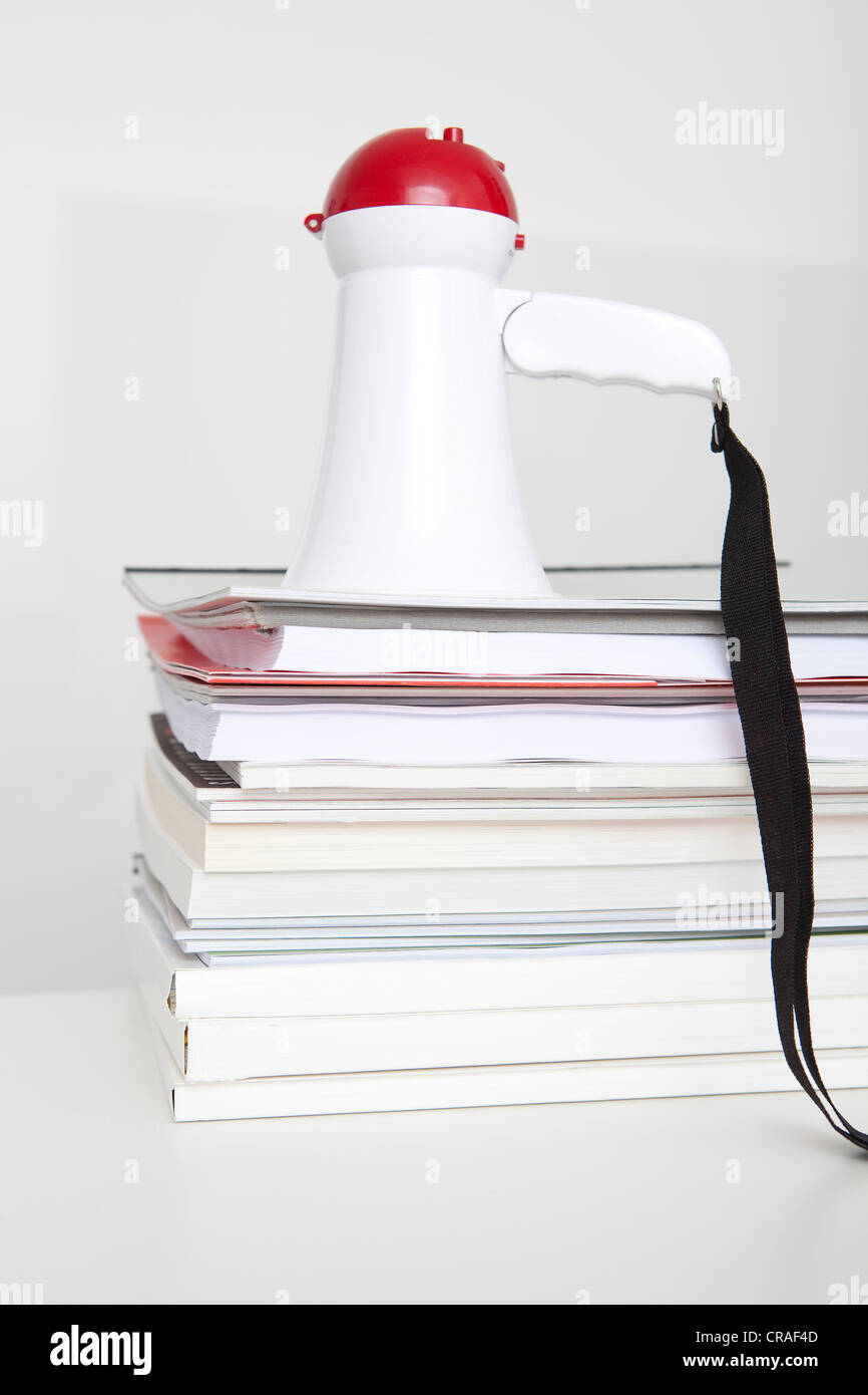 Megaphone on a stack of paper work, office, symbolic image for clear ...