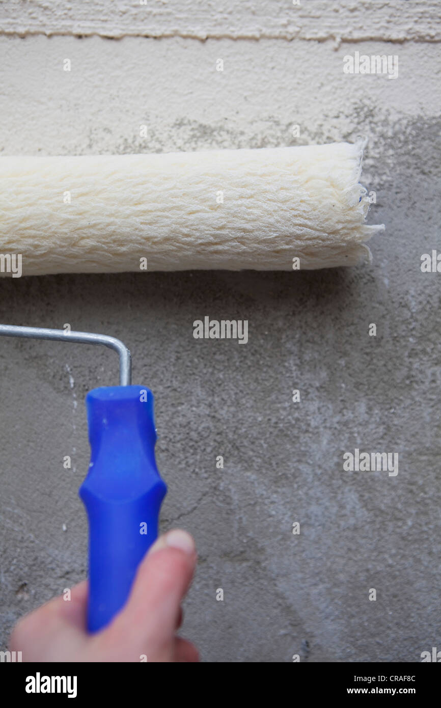 Painting with a paint roller Stock Photo - Alamy