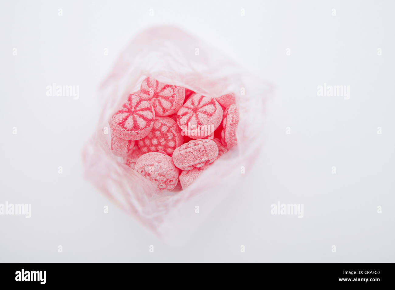 Raspberry candies from the bag Stock Photo - Alamy
