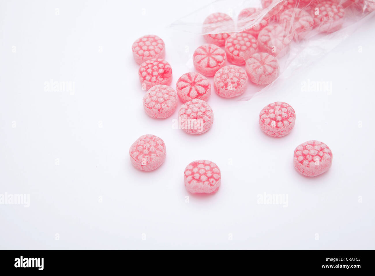 Raspberry candies from the bag Stock Photo - Alamy