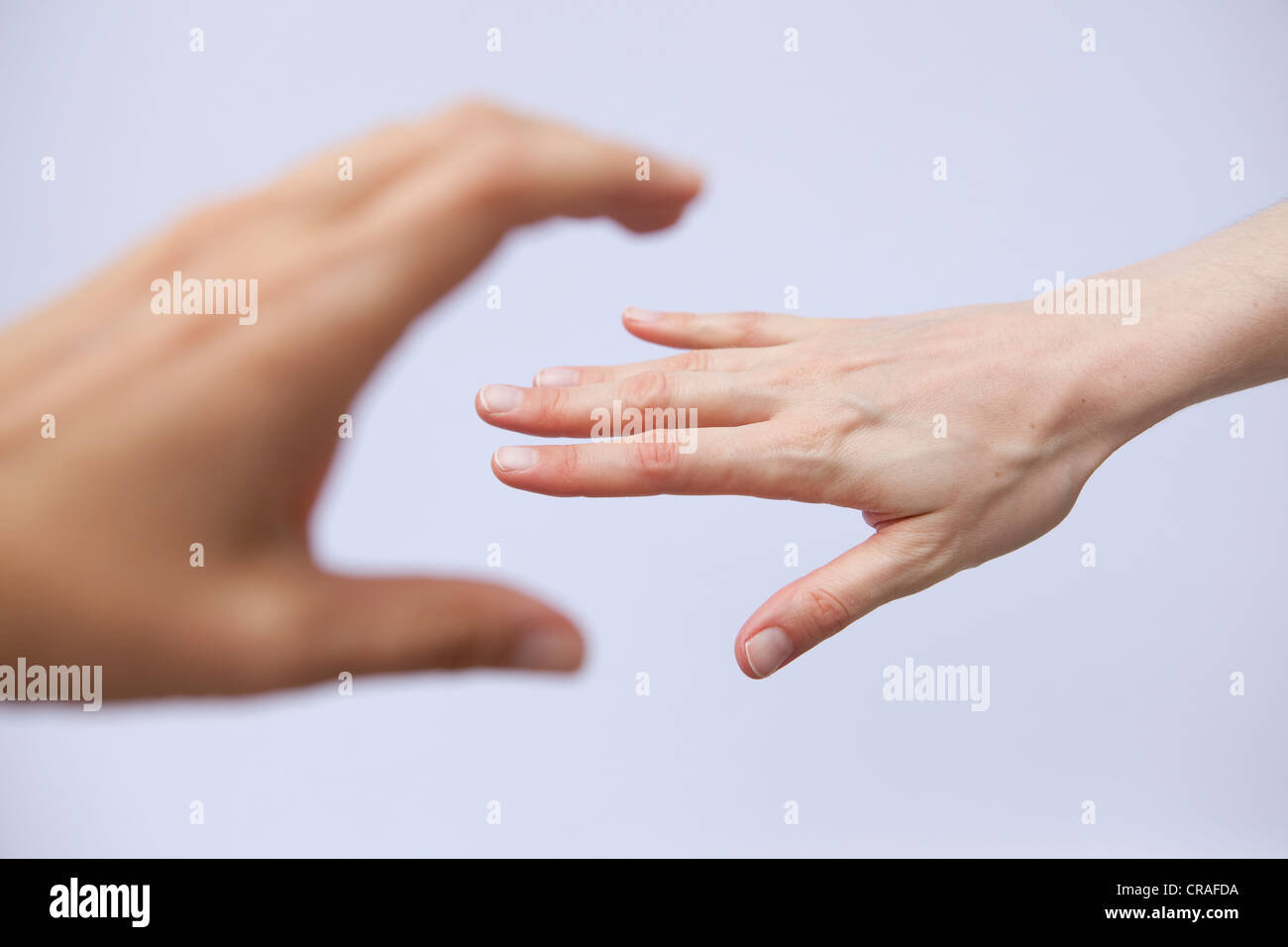 Hand reaching for another hand Stock Photo - Alamy