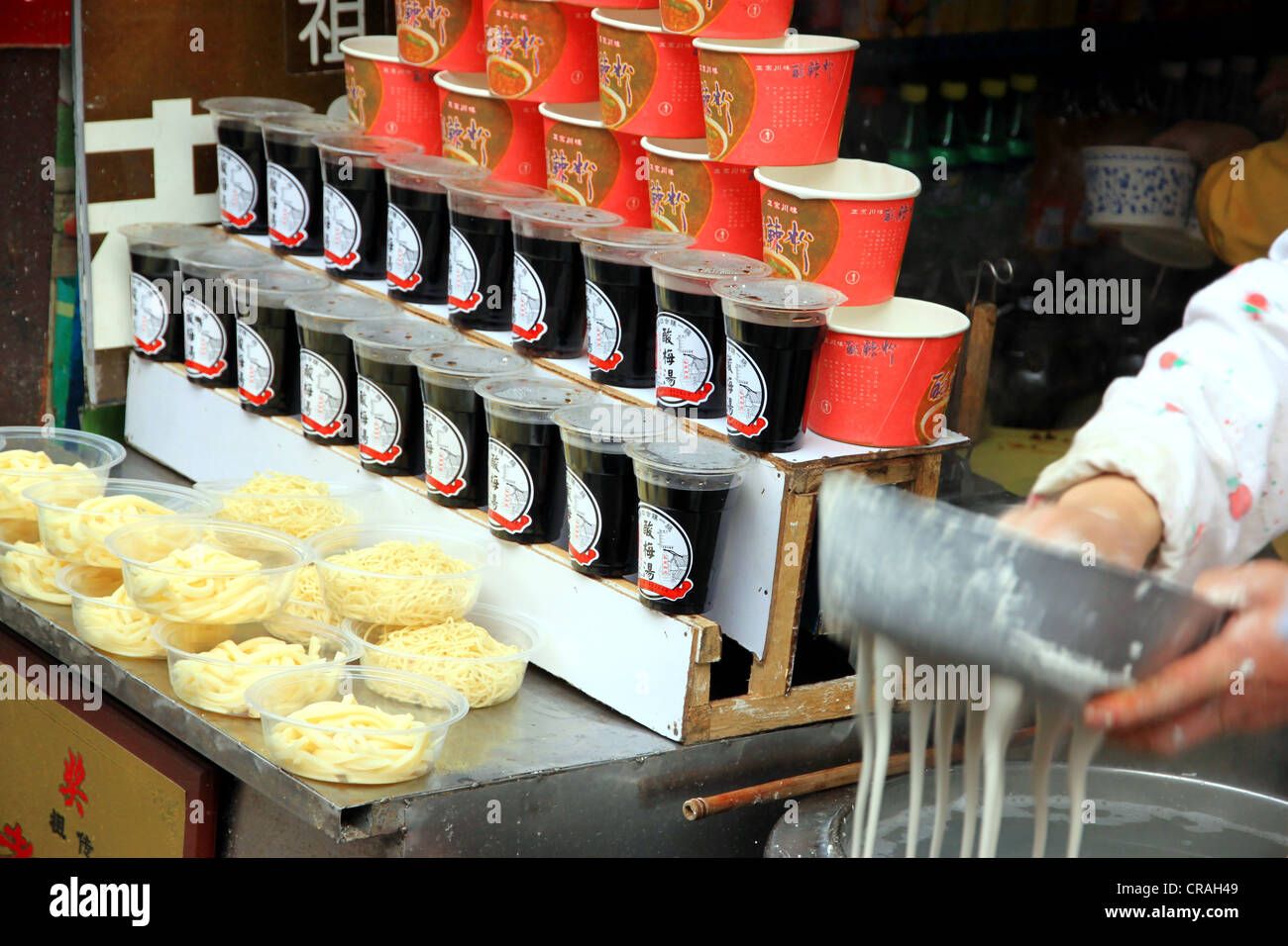 A noodles maker selling in a street of old Chongqing Stock Photo - Alamy