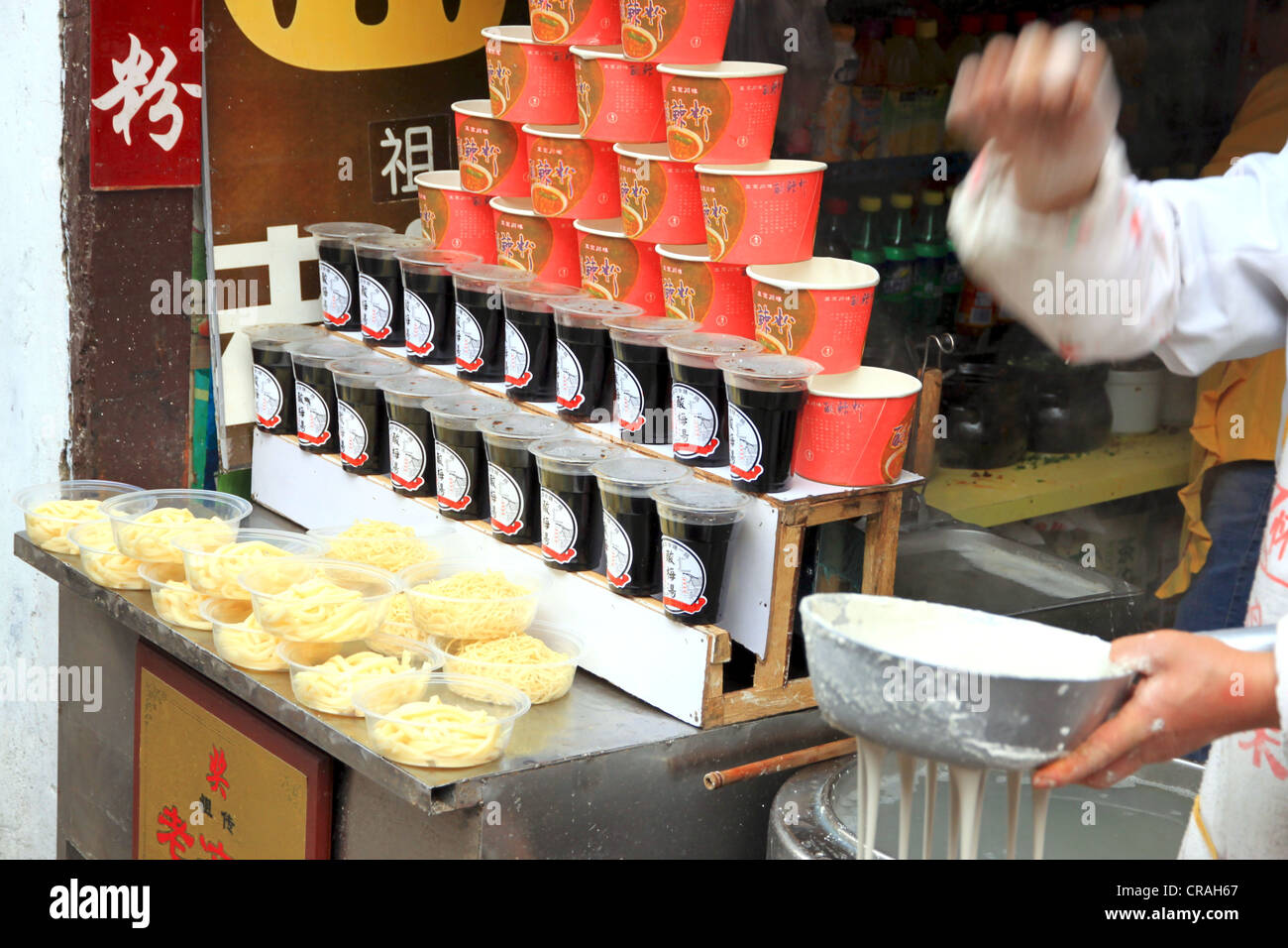 A noodles maker selling in a street of old Chongqing Stock Photo - Alamy