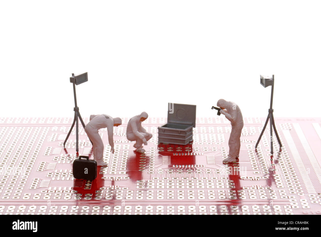 Forensic team figures on a red circuit board, symbolic image for ...