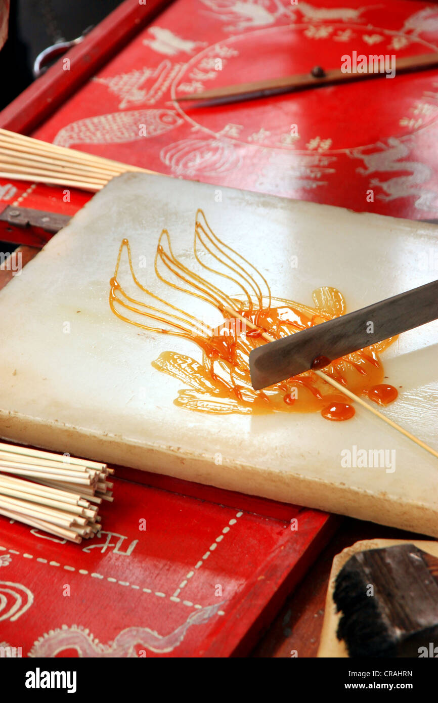 A candy maker selling his treats in a street of Chongqing Stock Photo ...