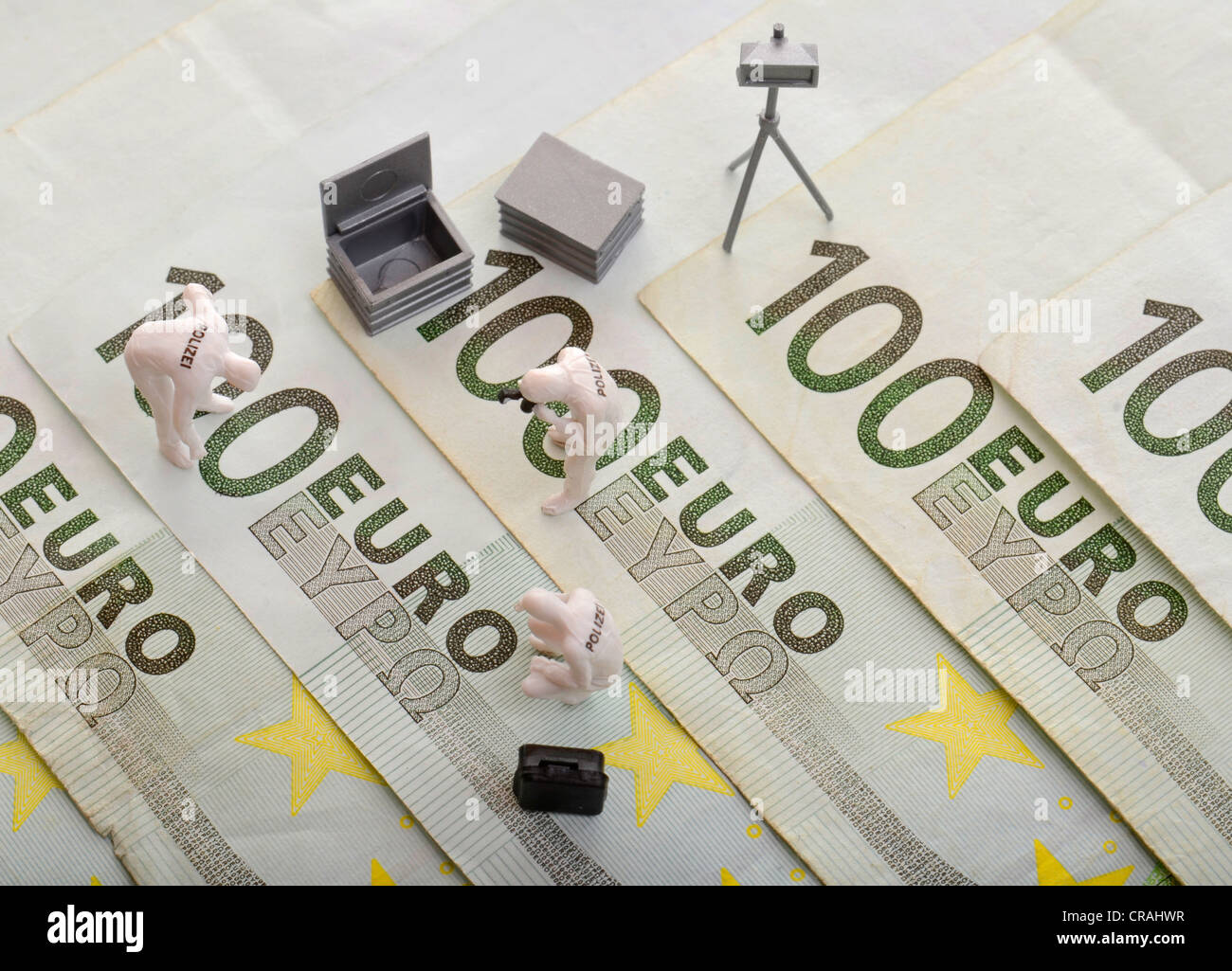 Securing of evidence, miniature figures standing on euro banknotes ...