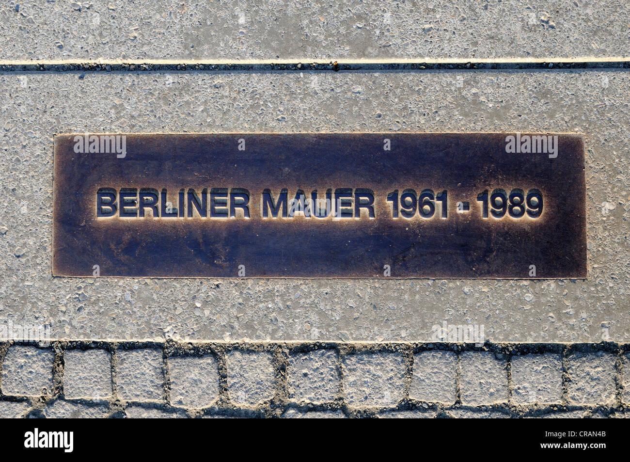 Bronze plaque marking the course of the Berlin Wall with the dates of ...