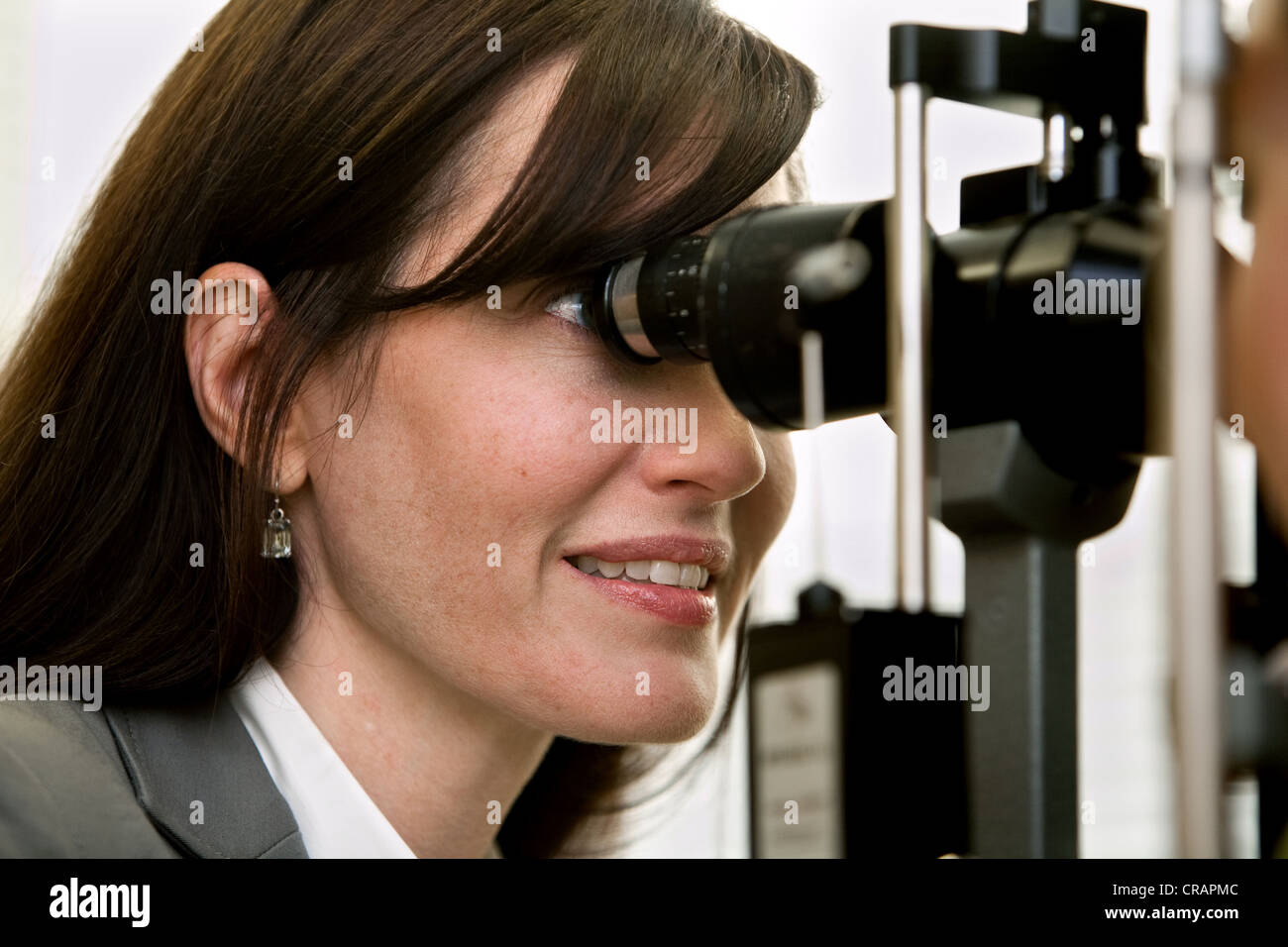 An eye doctor examines a patient Stock Photo - Alamy