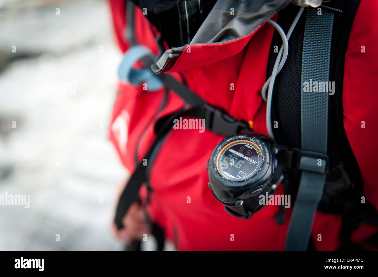Hiker carrying a multi-function watch on an outdoor jacket, East ...