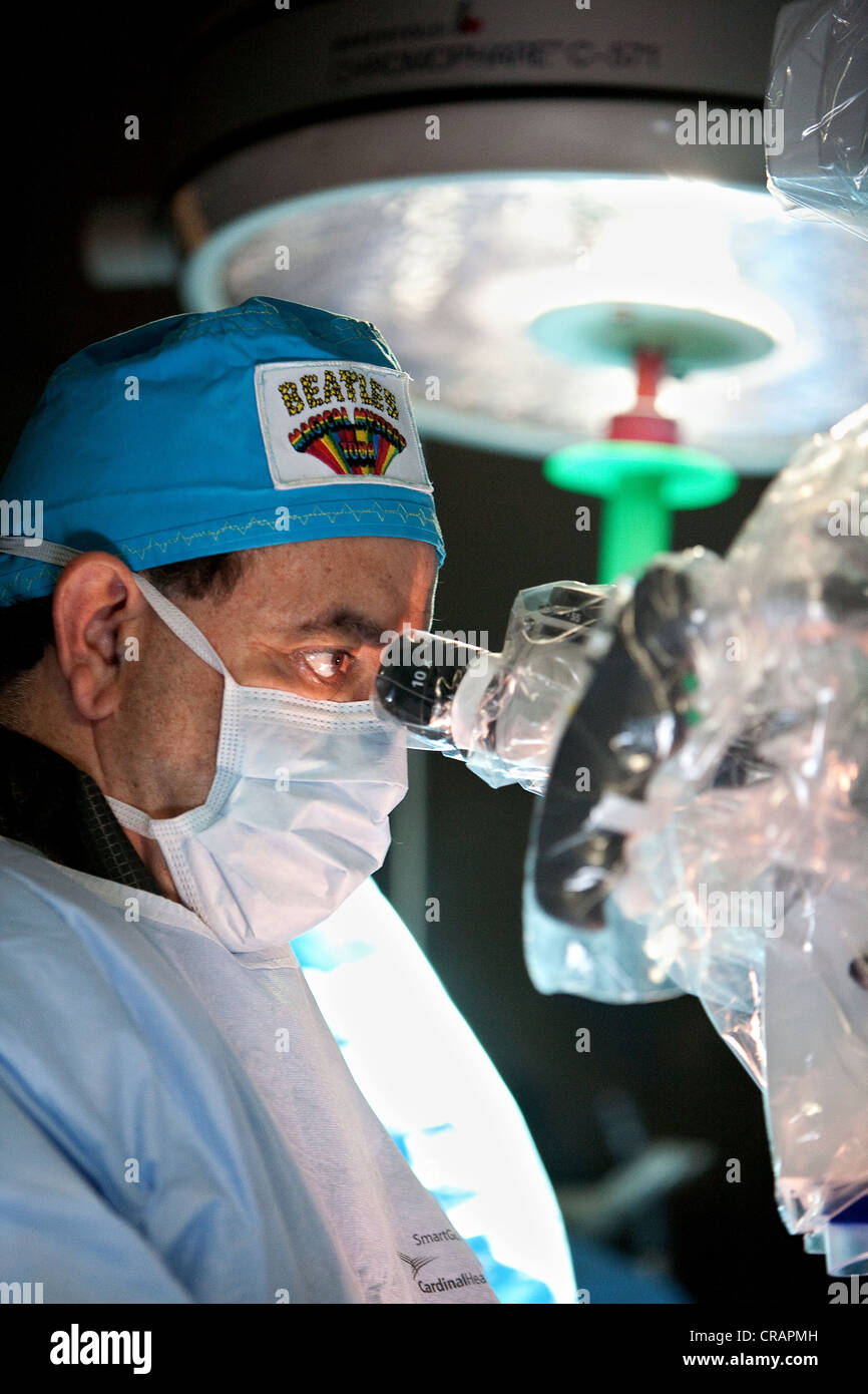 Doctor looks through microscope during eye surgery Stock Photo - Alamy