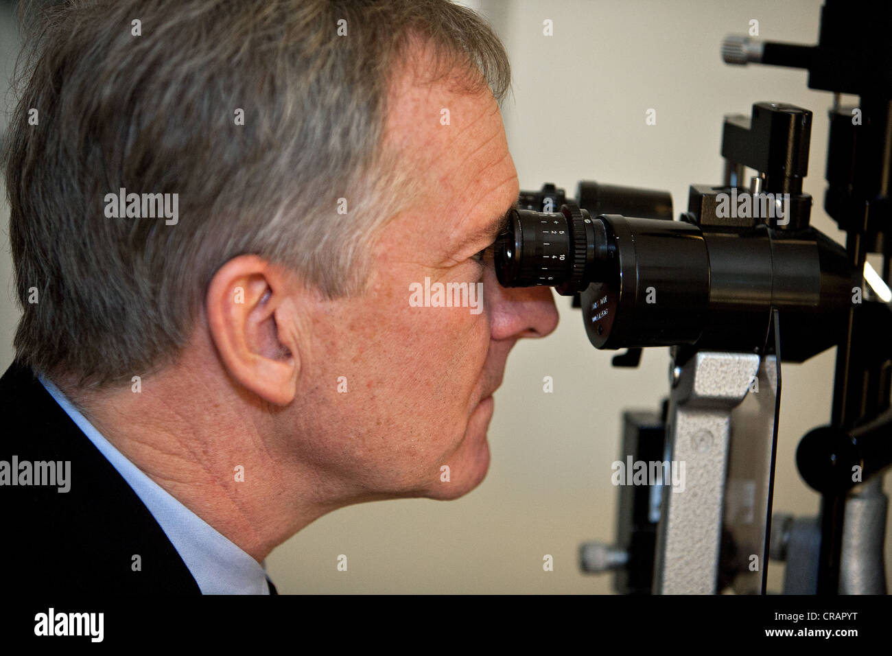 An eye doctor examines a patient Stock Photo - Alamy