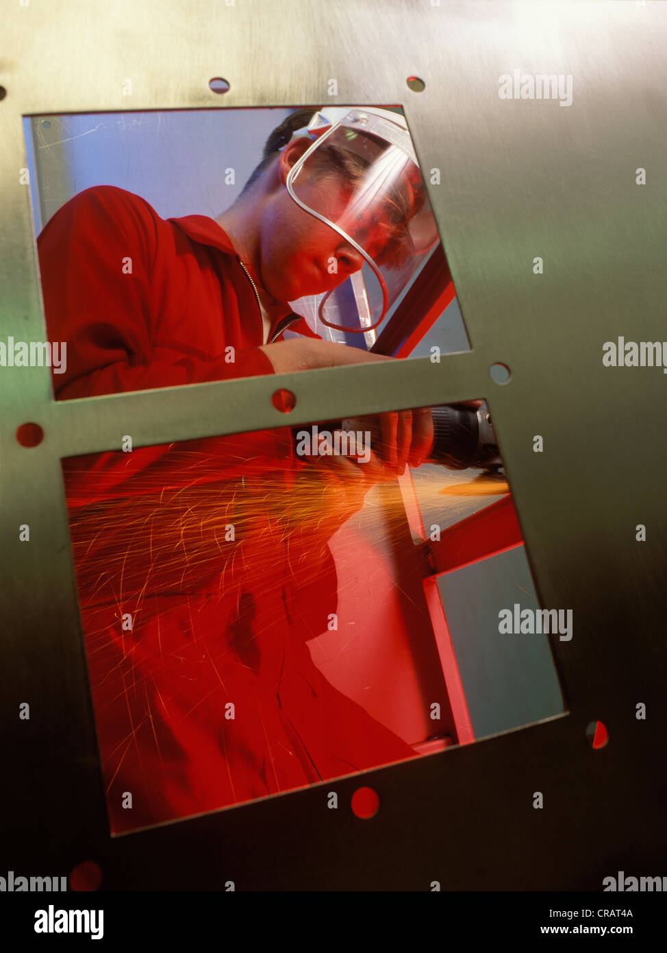 Engineer finishing boxes for electrical emgineering with angle grinder ...