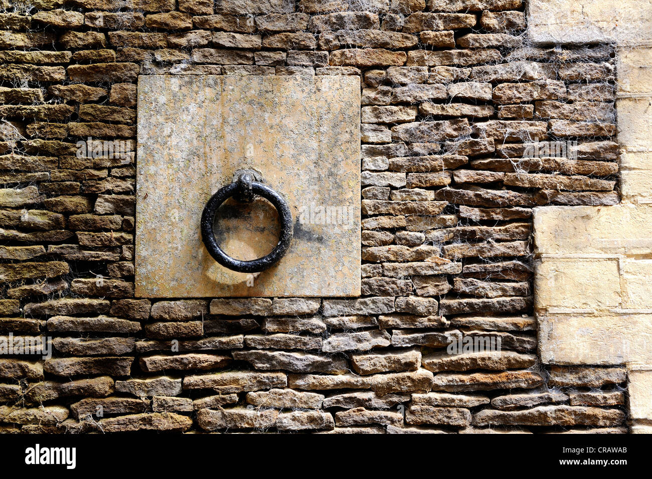 Metal ring mounted into a limestone block and cemented into a stone ...