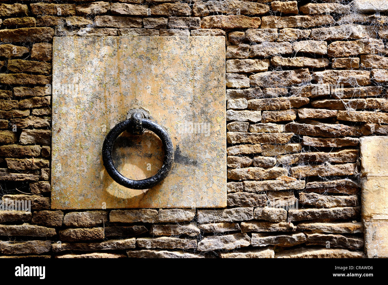 Metal ring mounted into a limestone block and cemented into a stone ...