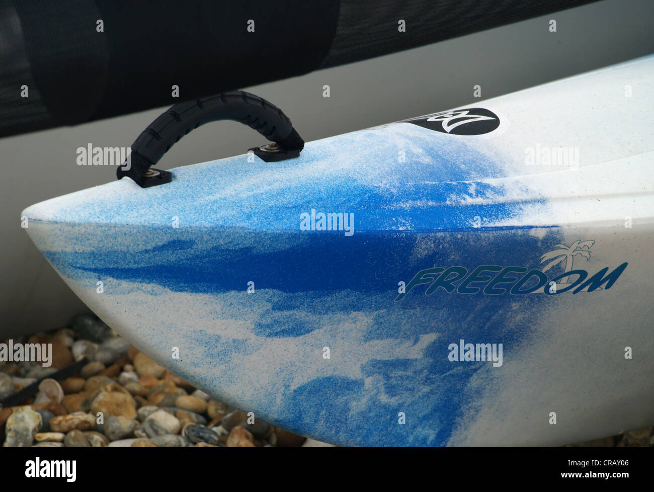 Front end of a blue and white kayak on a stony beach Stock Photo - Alamy