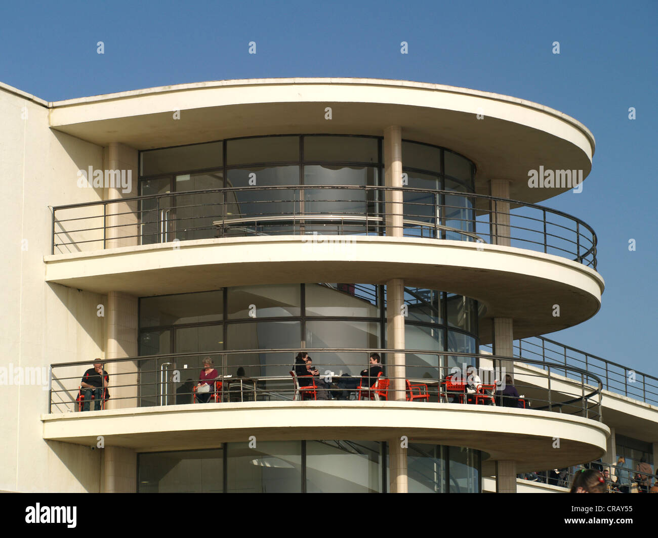 People relaxing on a semi circle balcony cafe in the sunshine, Bexhill ...