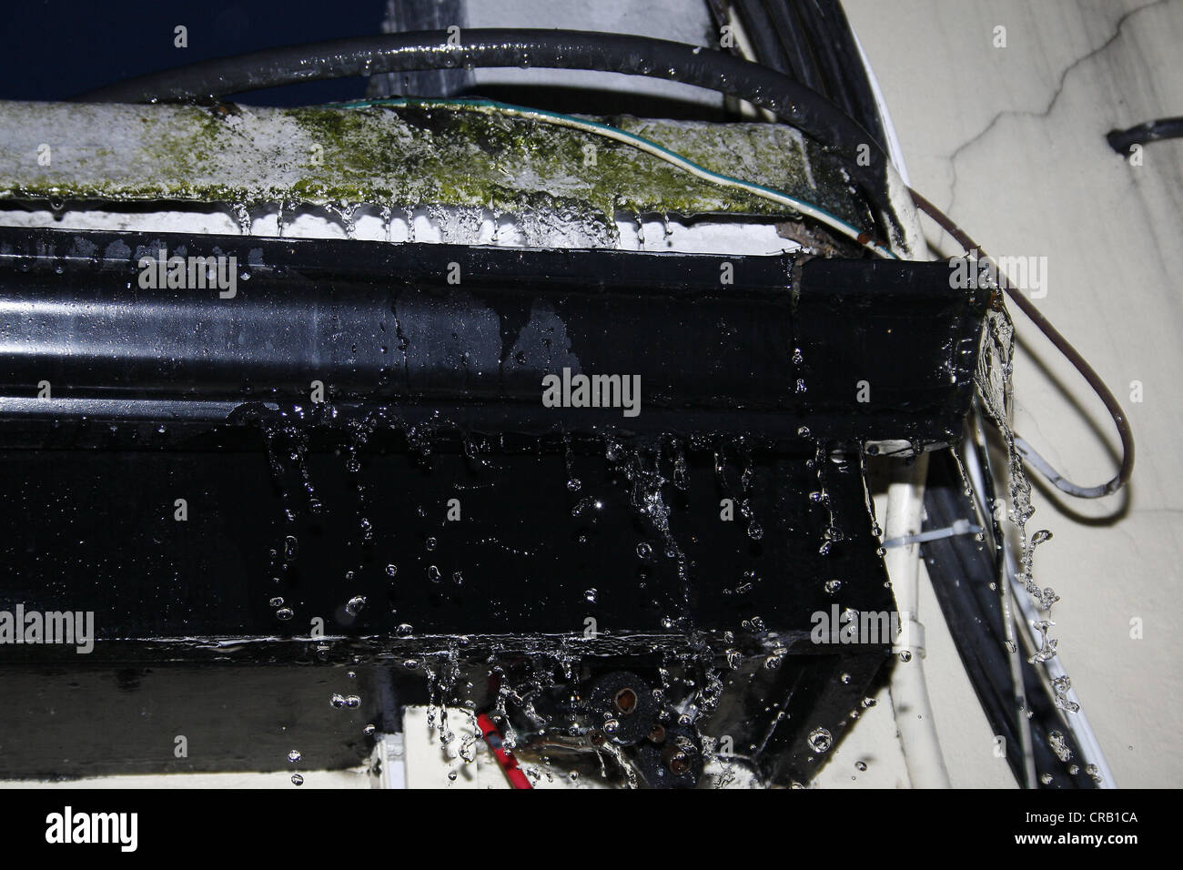 rain overflowing from blocked gutter of pub Stock Photo - Alamy