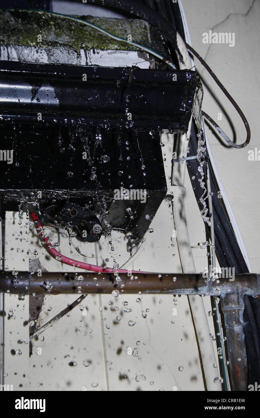 rain overflowing from blocked gutter of pub Stock Photo - Alamy