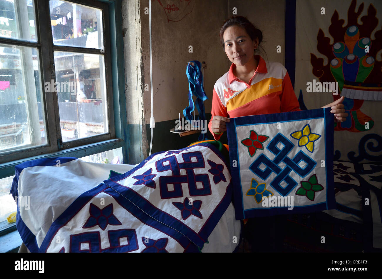 Tibetan handicrafts, dressmaker with Buddhist symbols on textiles ...