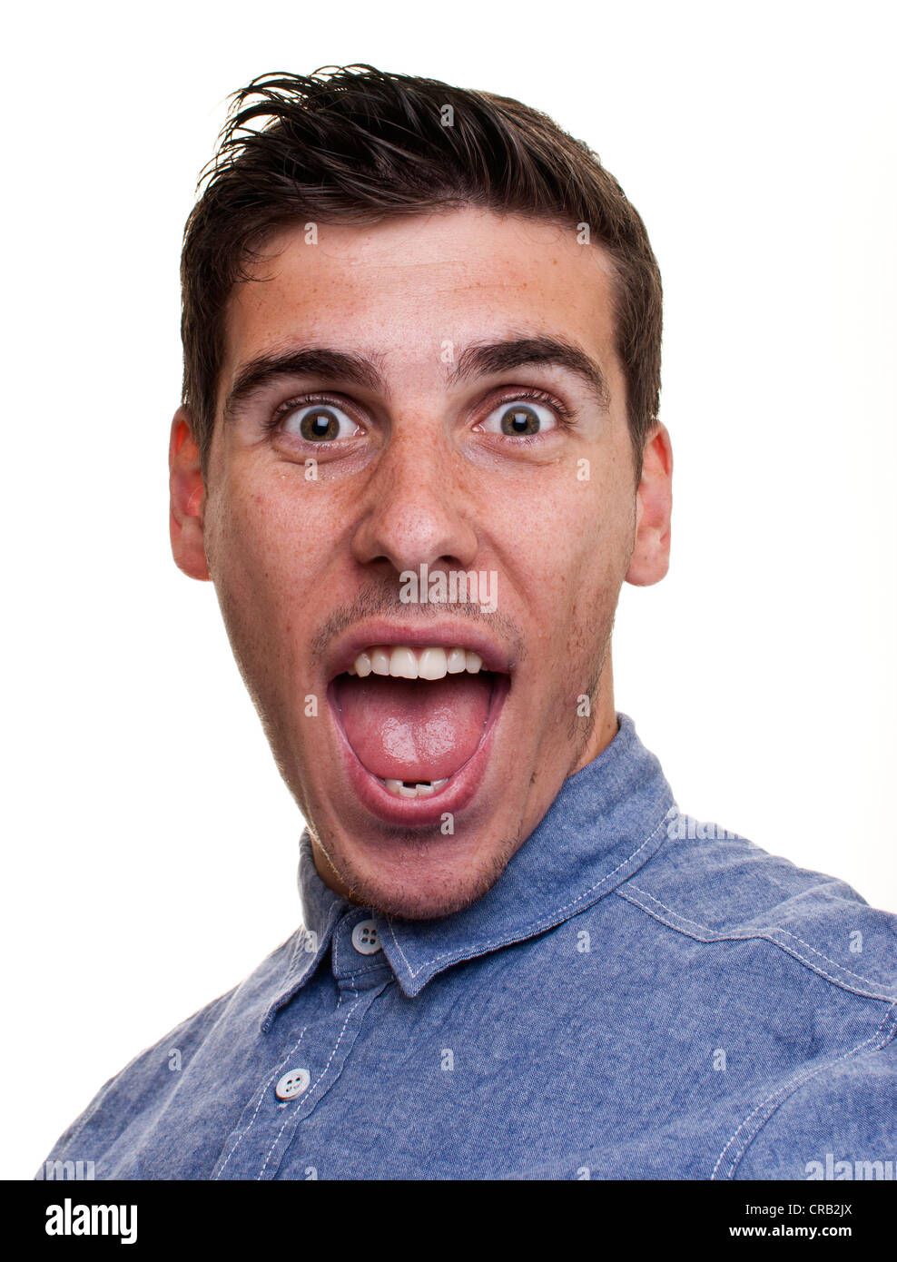 A man showing a **** expression in a blue shirt on a white background ...