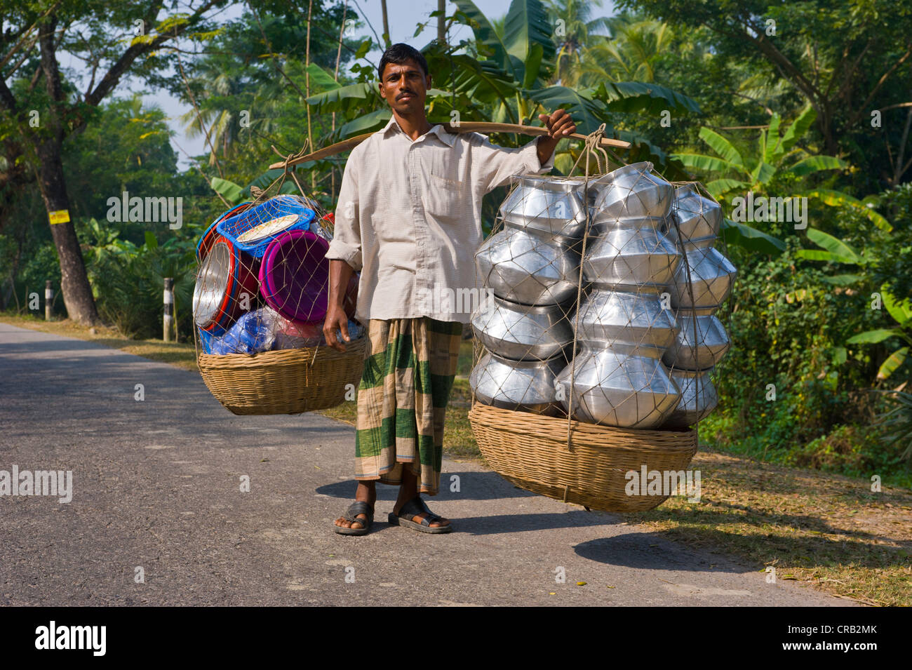 Man carrying many steel pots for sale, Bangladesh, Asia Stock Photo - Alamy