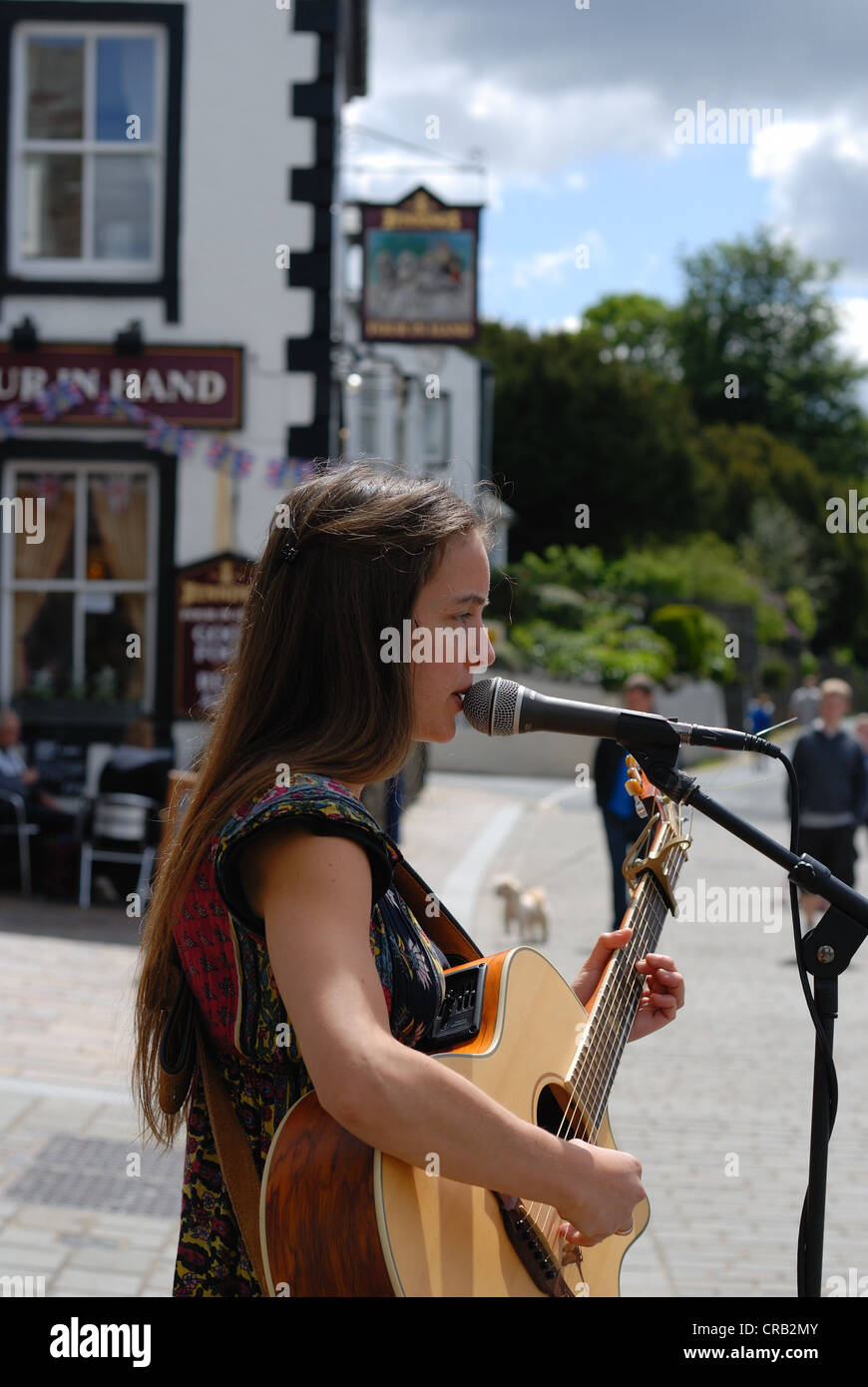 Olivia Fern, singer songwriter busking in Keswick Stock Photo - Alamy