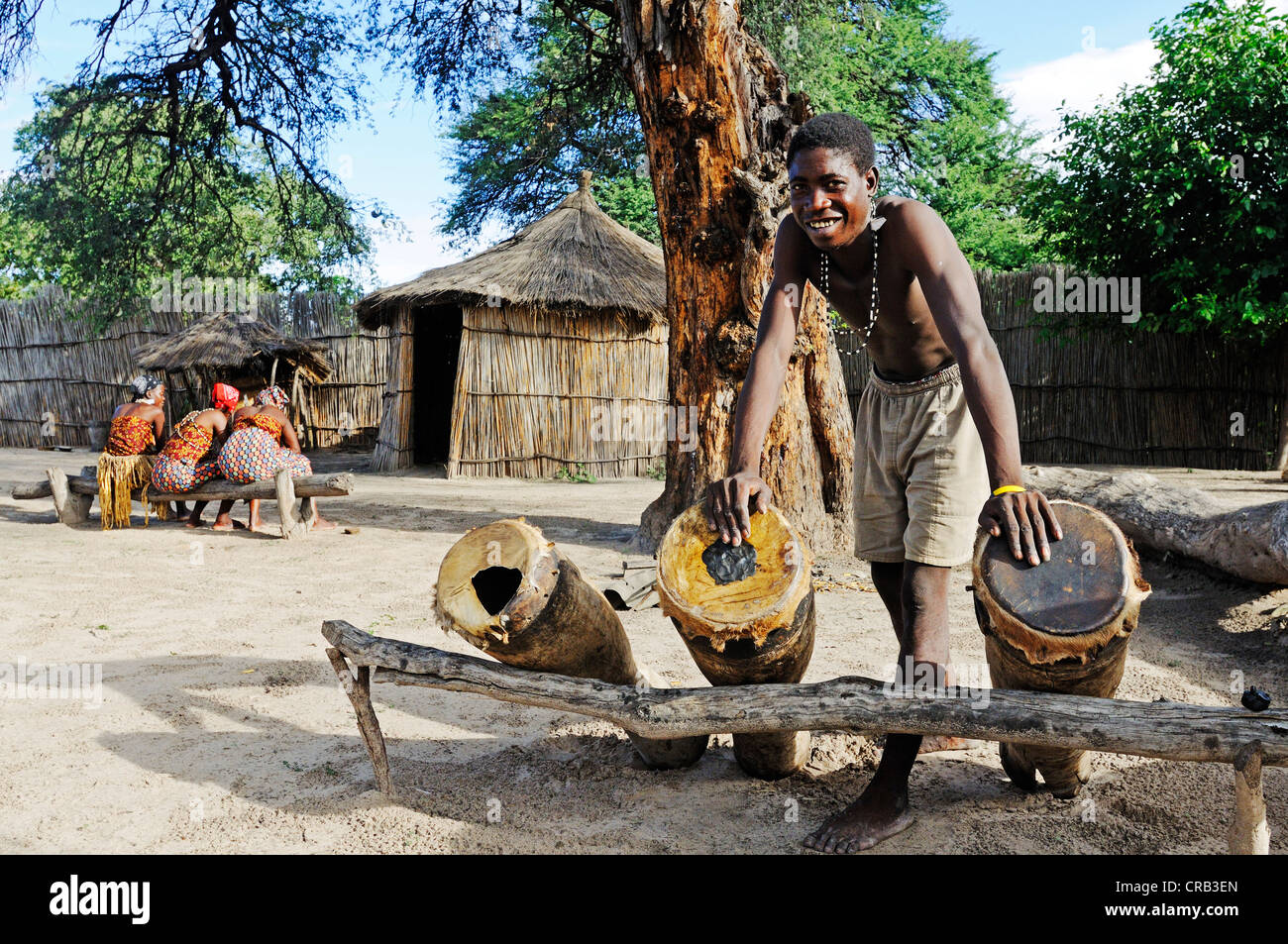 Drummer in a traditional village near Camp Kwando on the Kwando River ...