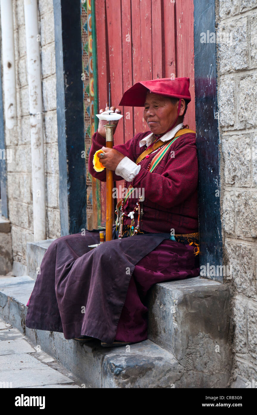Female monk with a prayer wheel, Lhasa, Tibet, Asia Stock Photo - Alamy