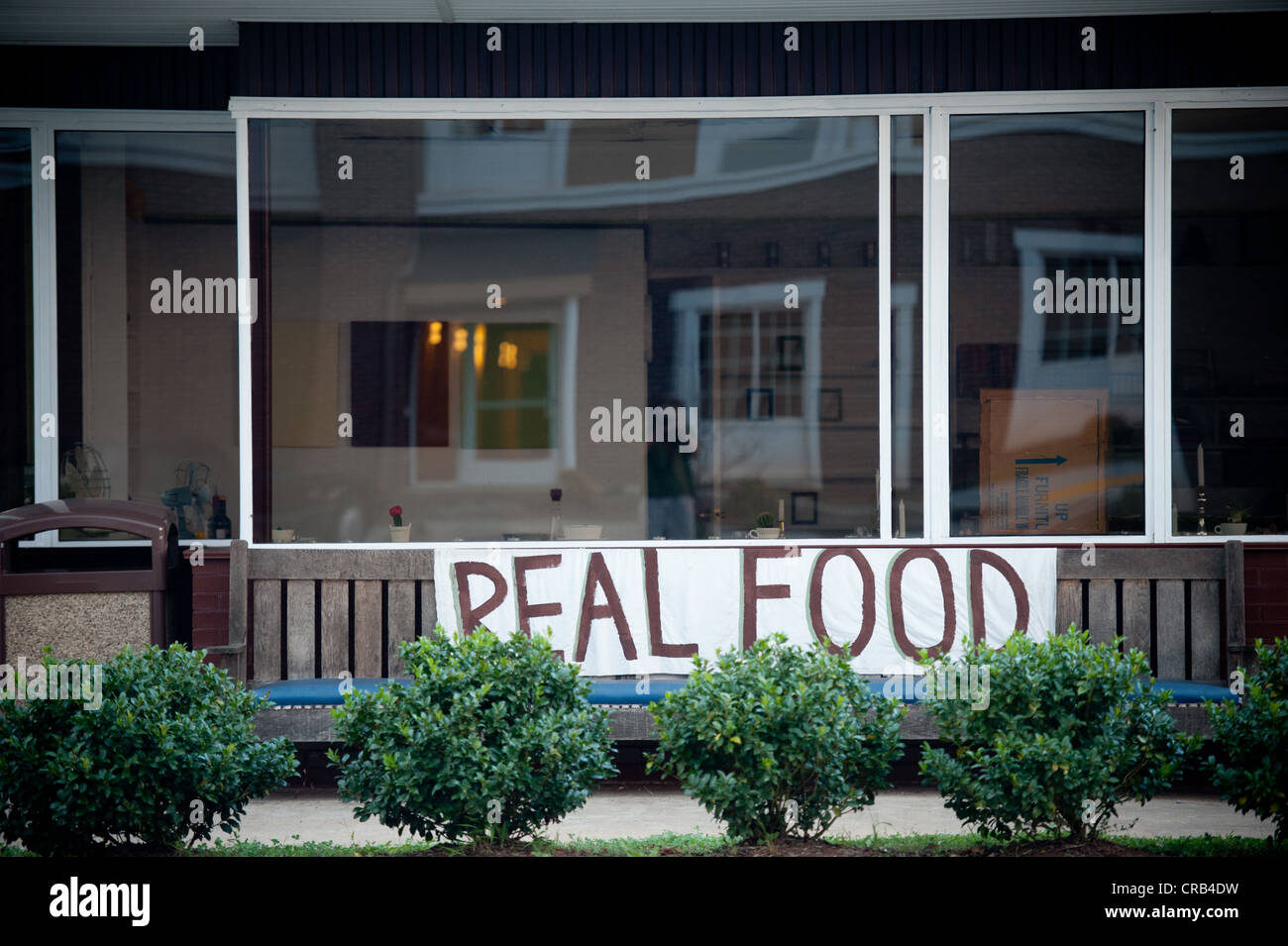 Real Food sign hanging on a window outside of a restaurant Stock Photo ...