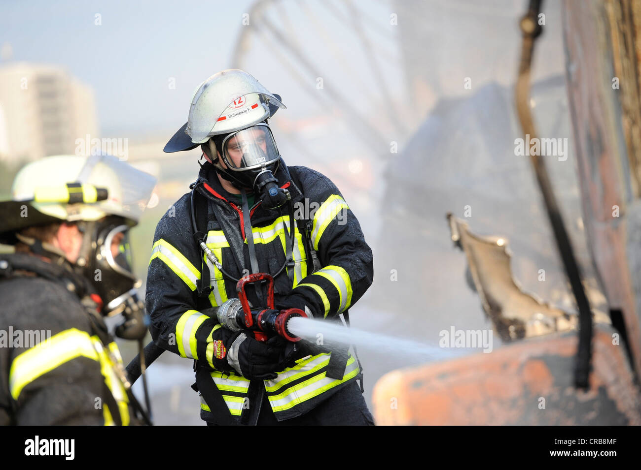 Firefighters extinguishing the fire of two burned-out trucks on the A8 ...