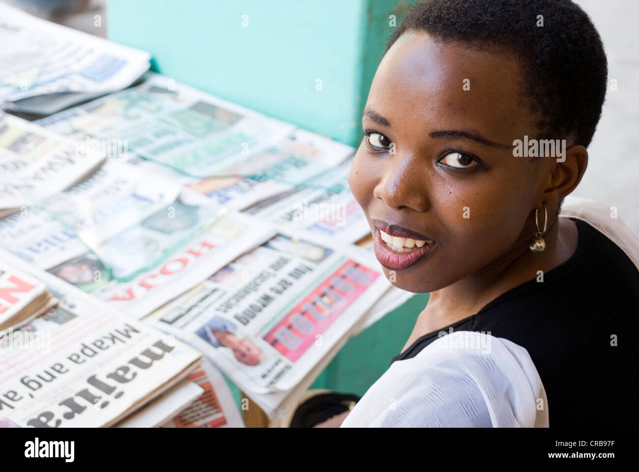 girl selling newspapers, arab quarter, dar es salaam, tanzania Stock ...