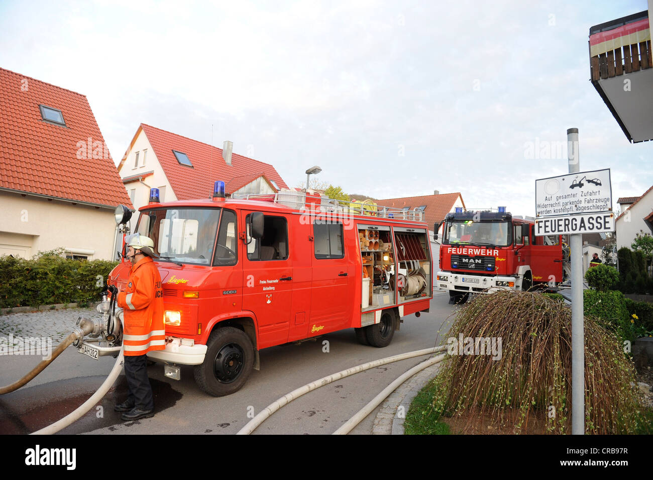 Fire engines during a fire fighting operation at a barn fire next to ...