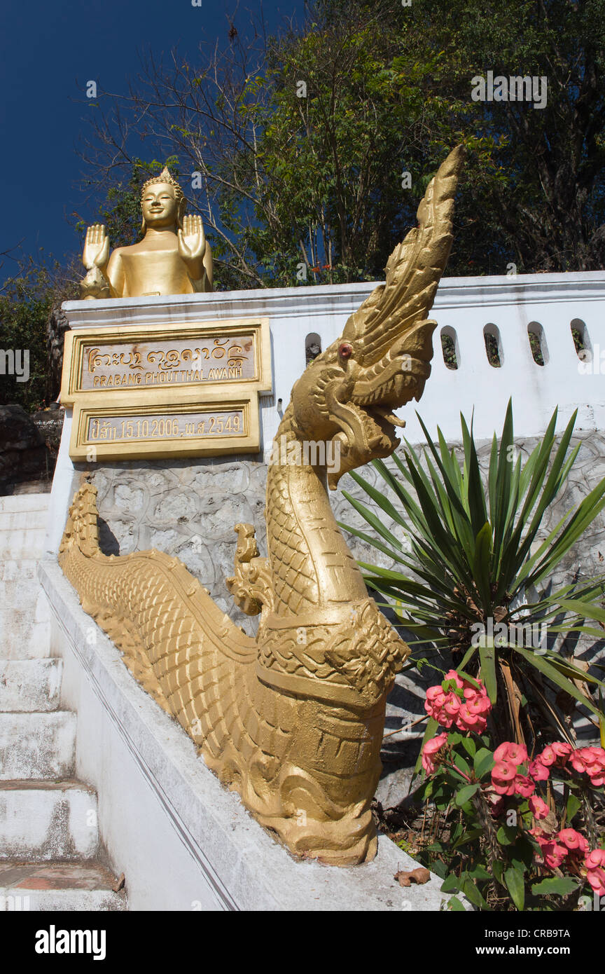 Standing Buddha statue at a temple on Phousi Mountain, Luang Prabang ...
