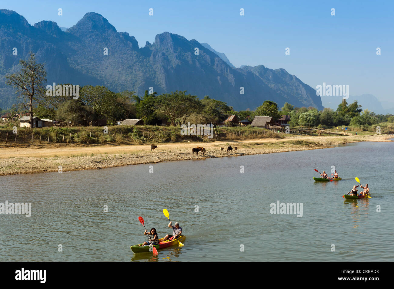 Canoeing on the Nam Song River, karst mountains at back, Vang Vieng ...