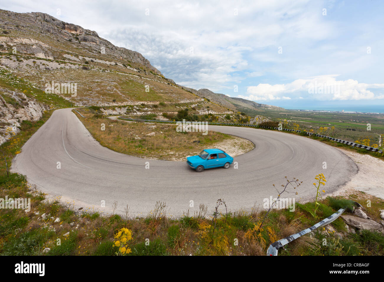 Car on a winding country road near Manfredonia, Foggia Province, Apulia ...