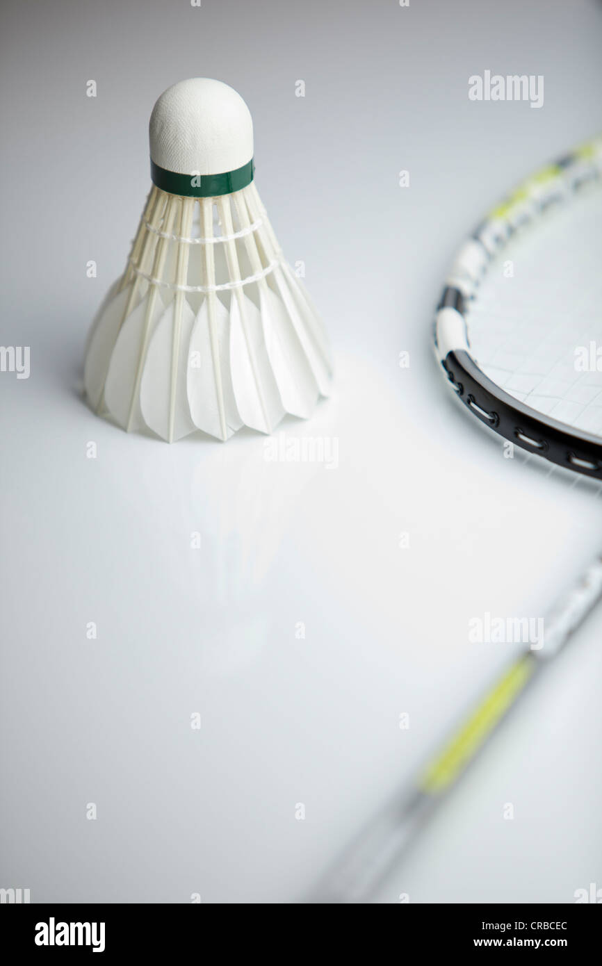 Badminton shuttlecock and racket on white background (shallow DOF ...