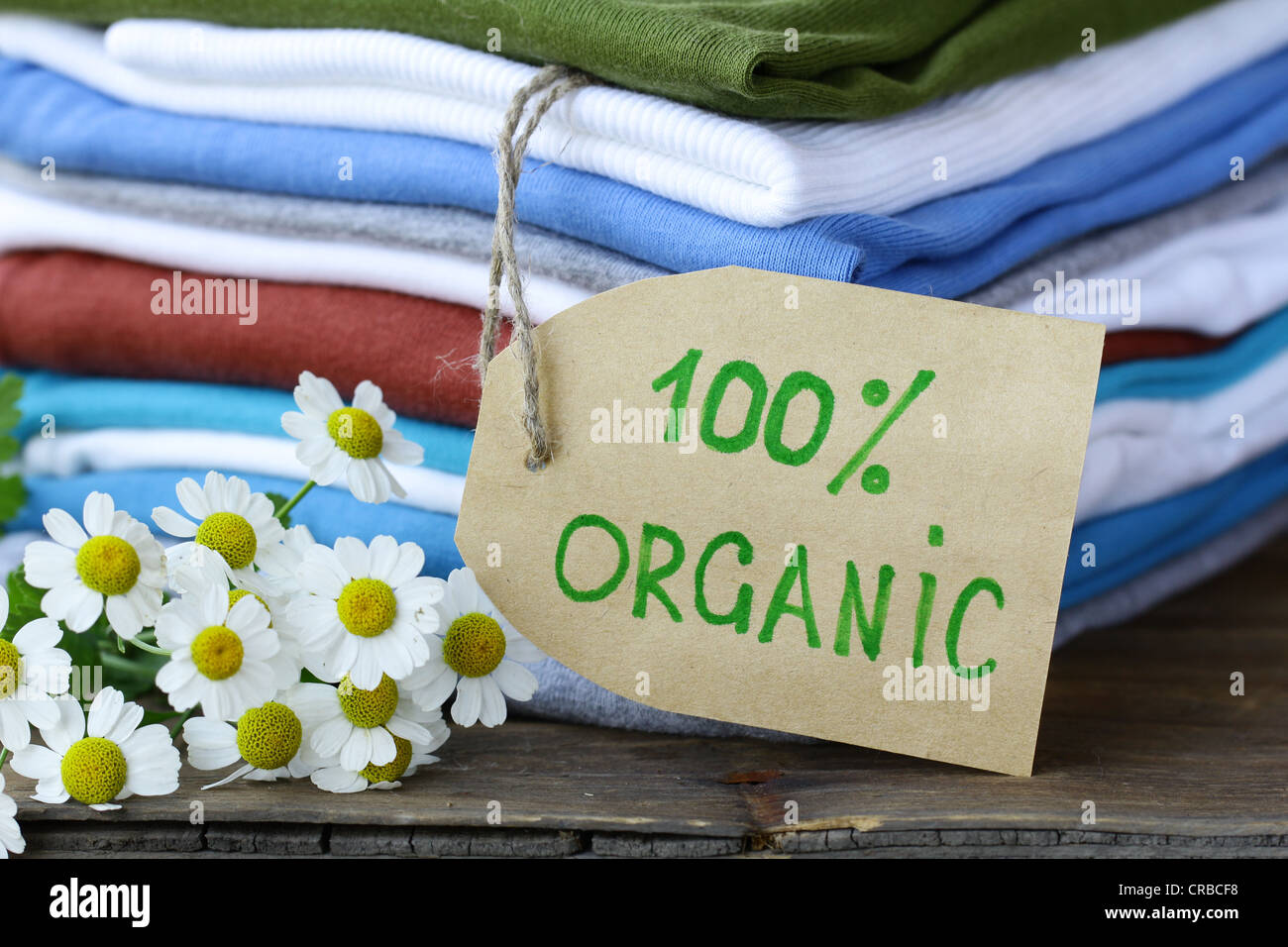 stack of colorful clothing with organic label Stock Photo - Alamy