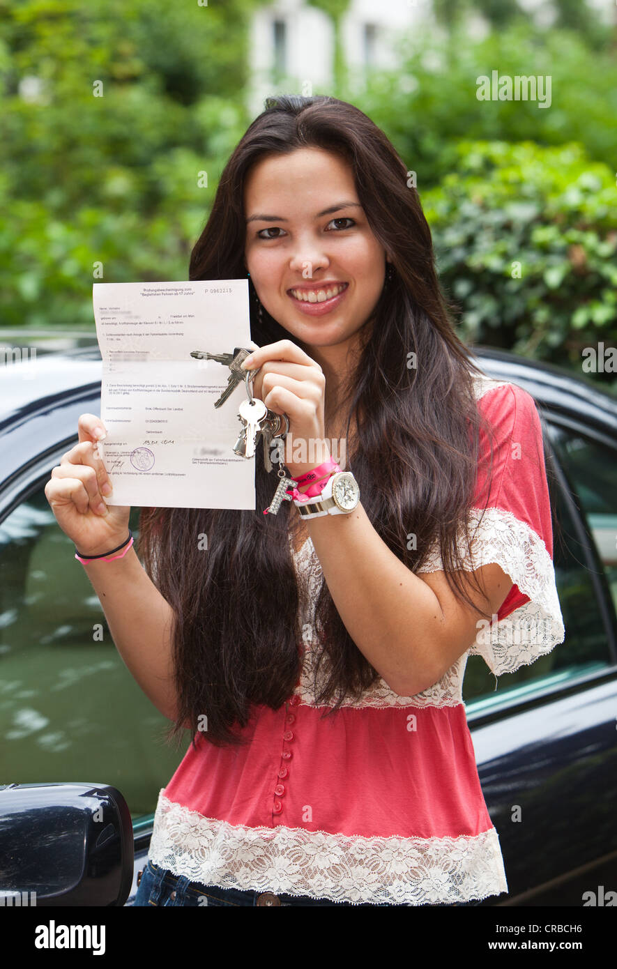 Girl, about 17 years, proudly presenting her driving license for ...
