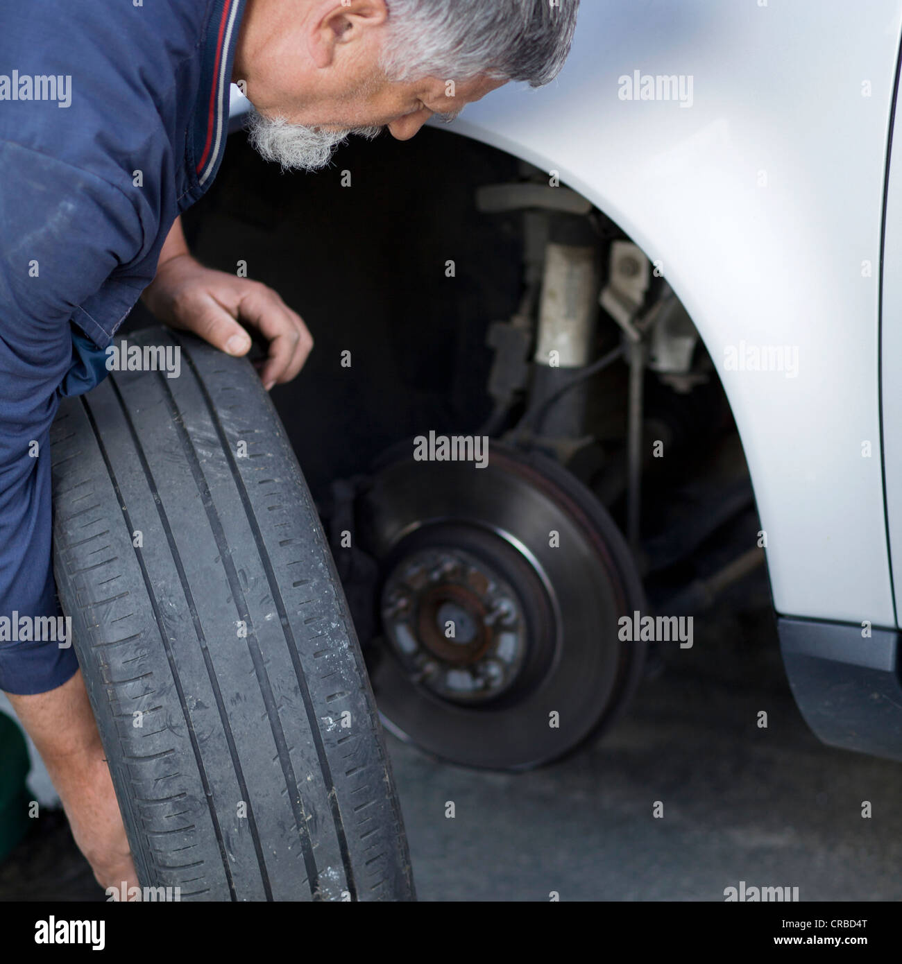 mechanic changing a wheel of a modern car (color toned image Stock ...