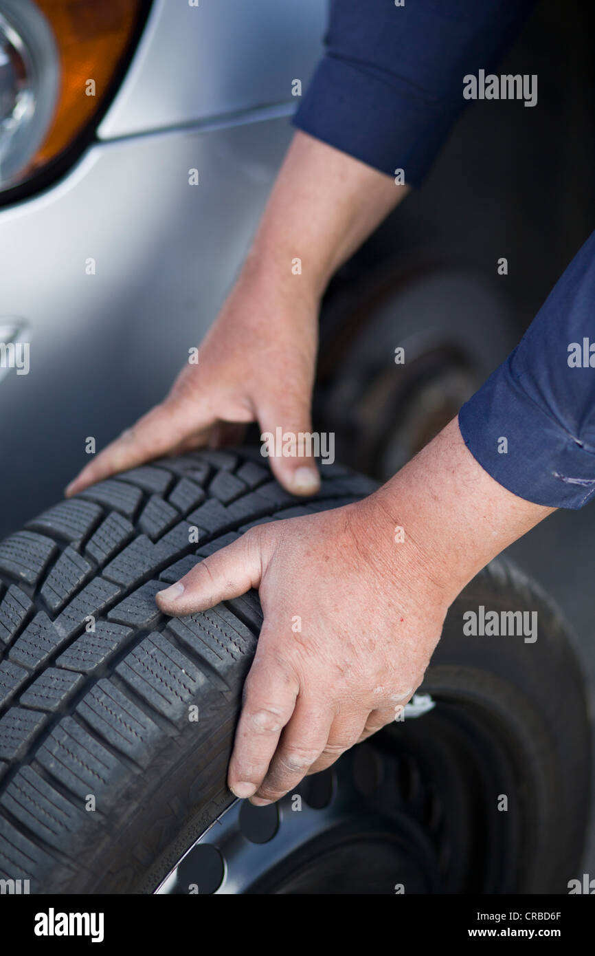 mechanic changing a wheel of a modern car (color toned image Stock ...